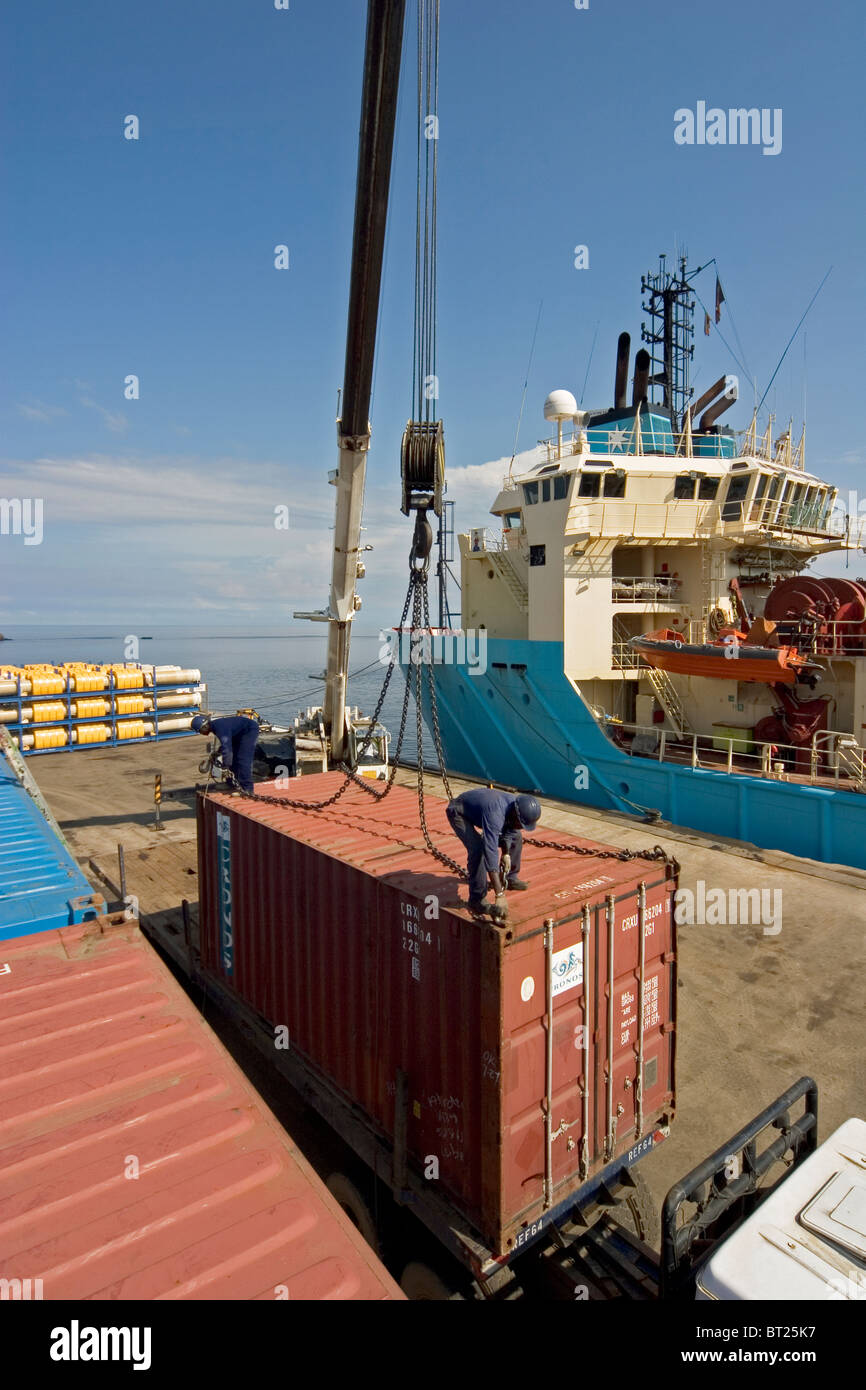 Luba Oil Freeport. Stevedores loading containers onto ship from ...