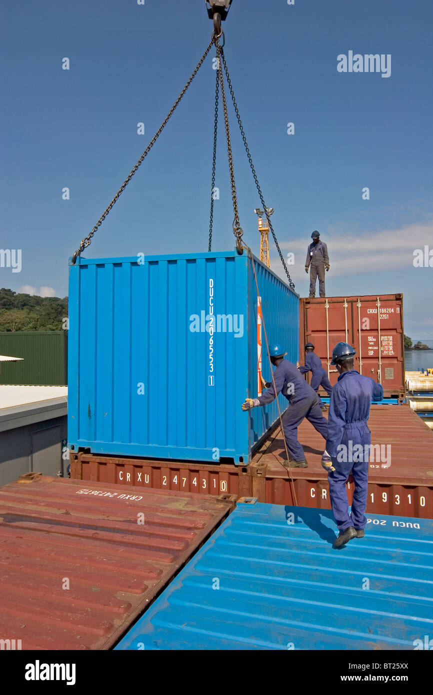 Luba Oil Freeport. Stevedores loading containers onto ship from ...