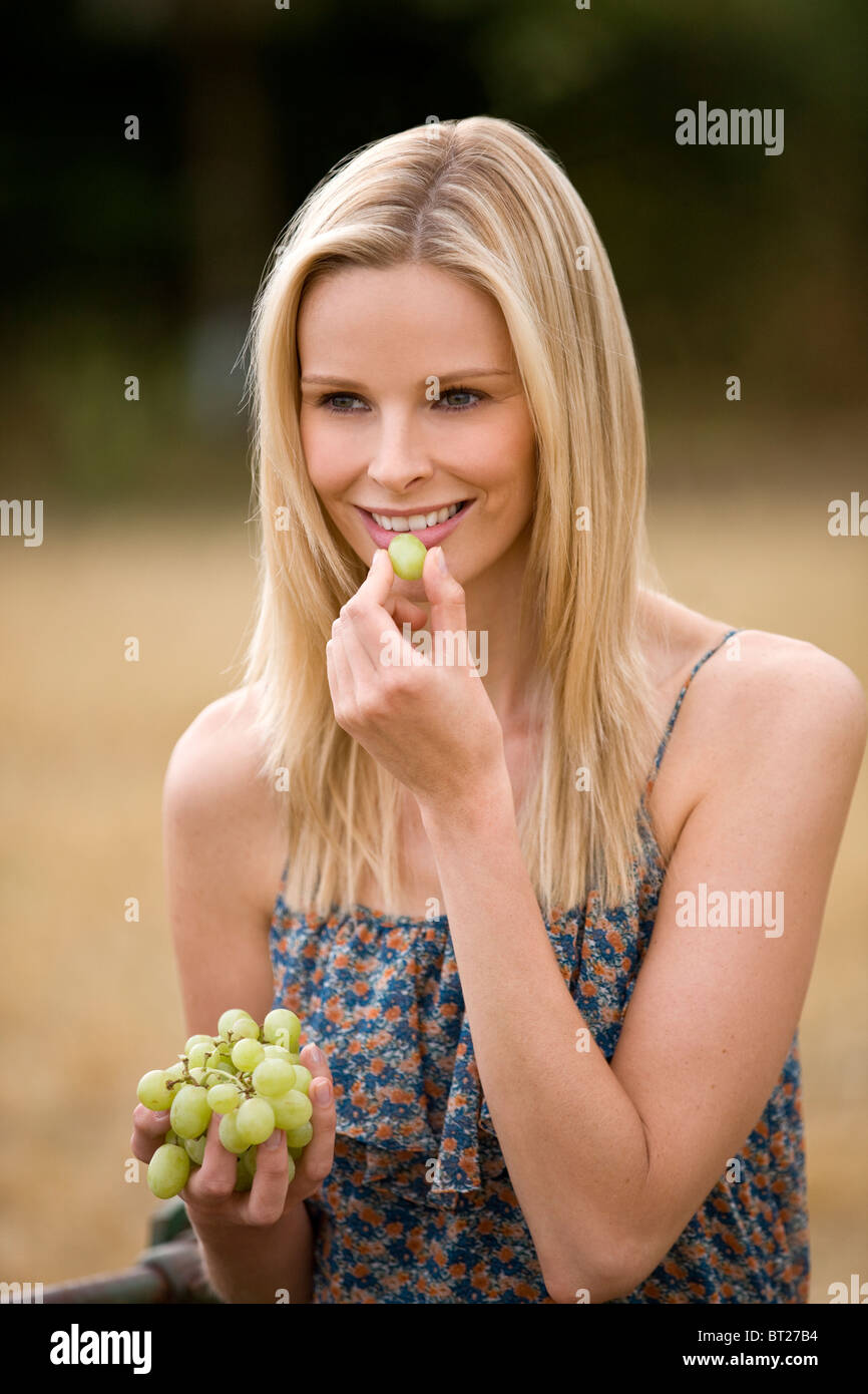 Woman eating grapes hi-res stock photography and images - Alamy