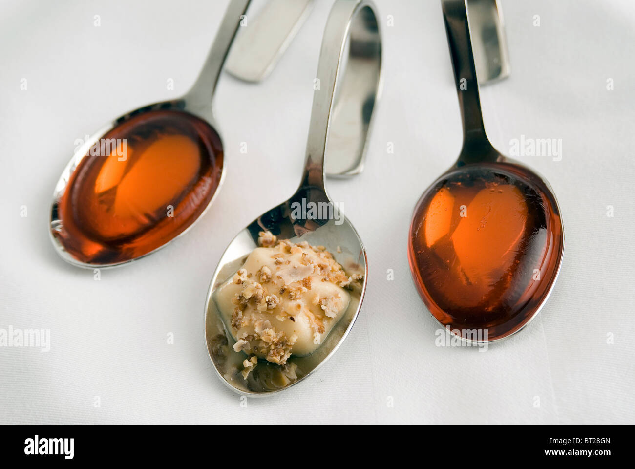 Three Spoons with honey and creme Stock Photo - Alamy