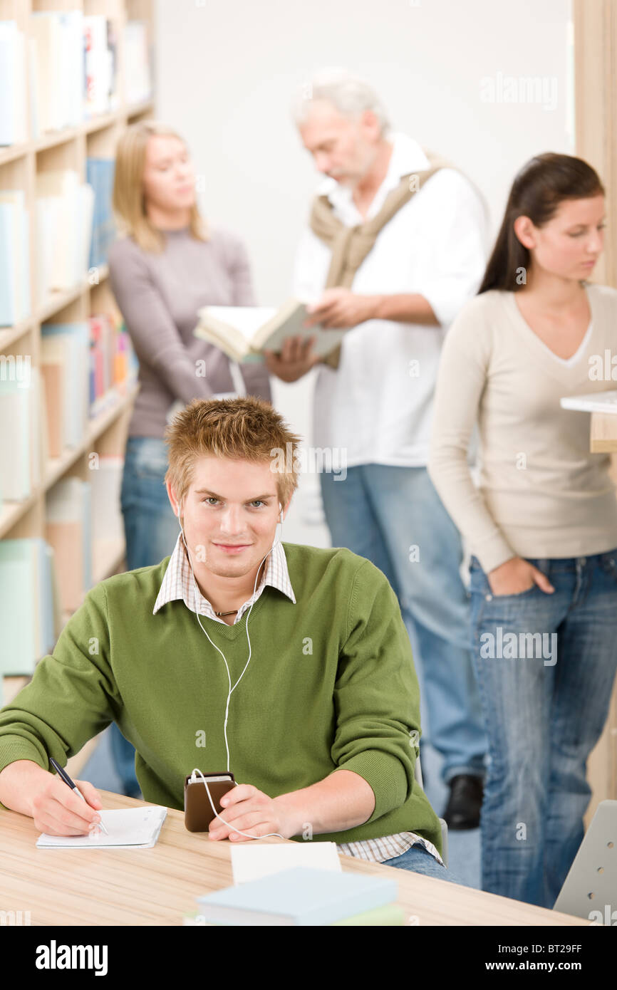 High school library - student with headphones listen to music Stock ...