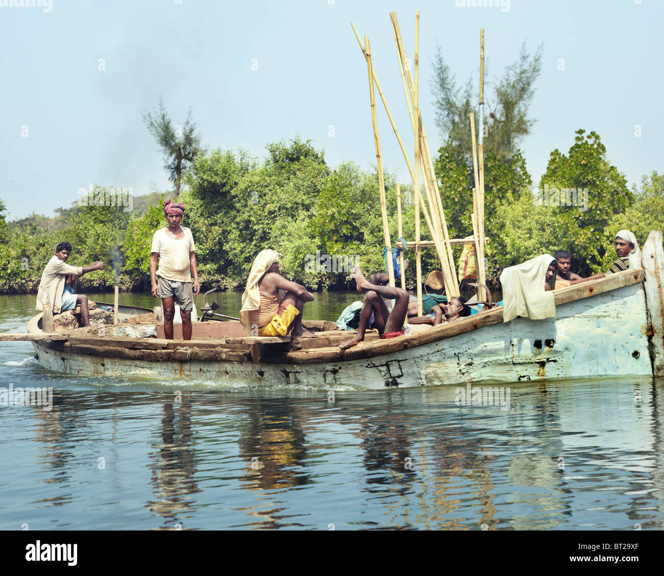Editorial photo of boat with prawn fishers in the river. India, Goa ...