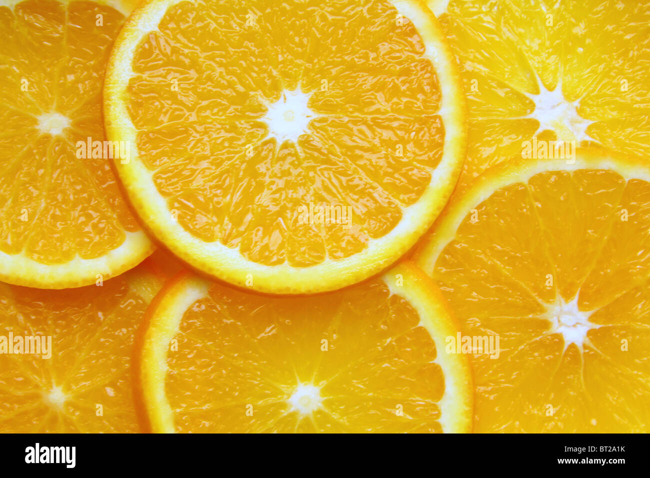 Orange sliced pieces of background Stock Photo - Alamy