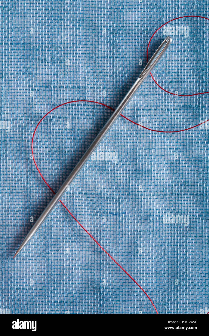 Sewing needle with thread Stock Photo - Alamy