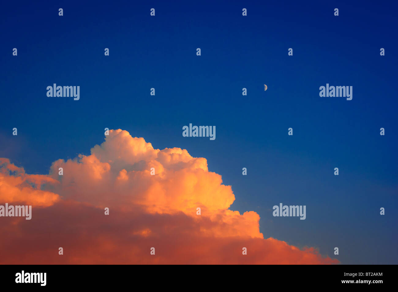 Magic view of deep blue sky, red orange clouds and moon Stock Photo - Alamy