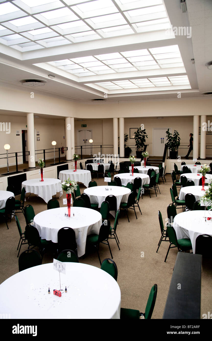 A glass roofed hall ready for a wedding reception and party to take ...