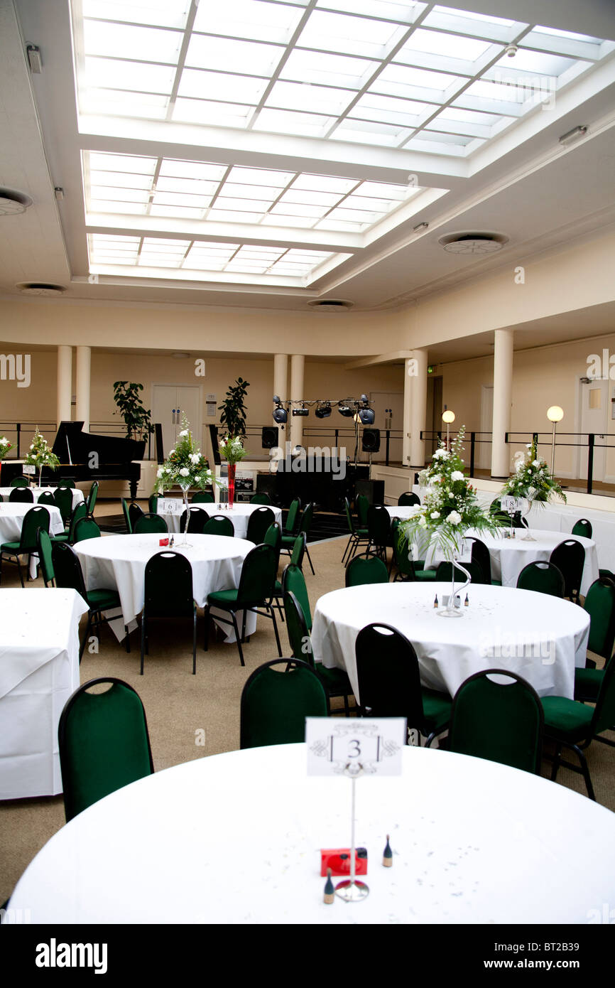 A glass roofed hall ready for a wedding reception and party to take ...