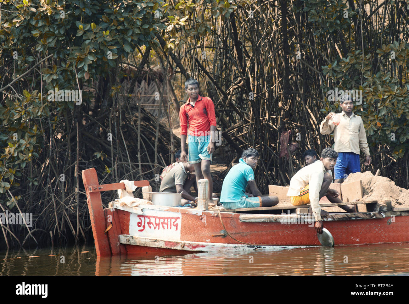 Editorial photo of the young workers at the boat flowing through the ...