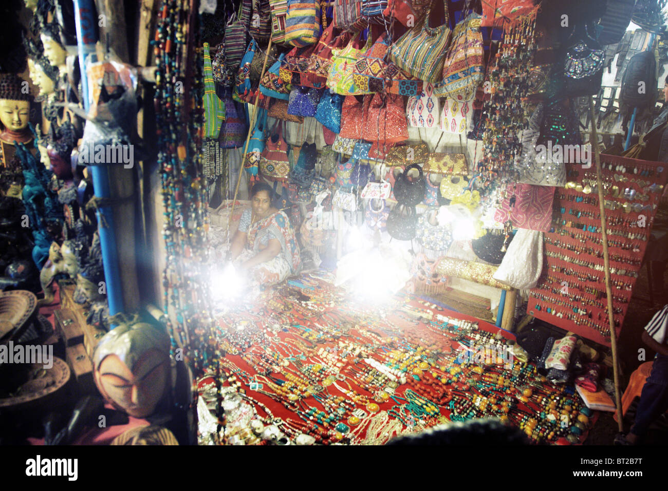 Editorial photo of the female trader sitting in her shop at the night ...
