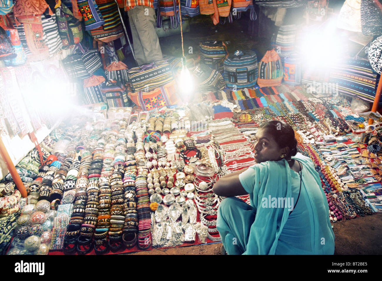 Editorial photo of the female trader sitting in her shop at the night ...