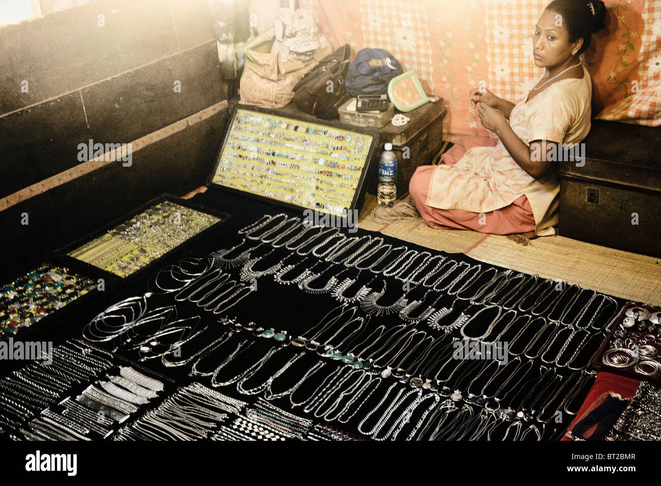 Editorial photo of the female trader sitting in her shop at the night ...