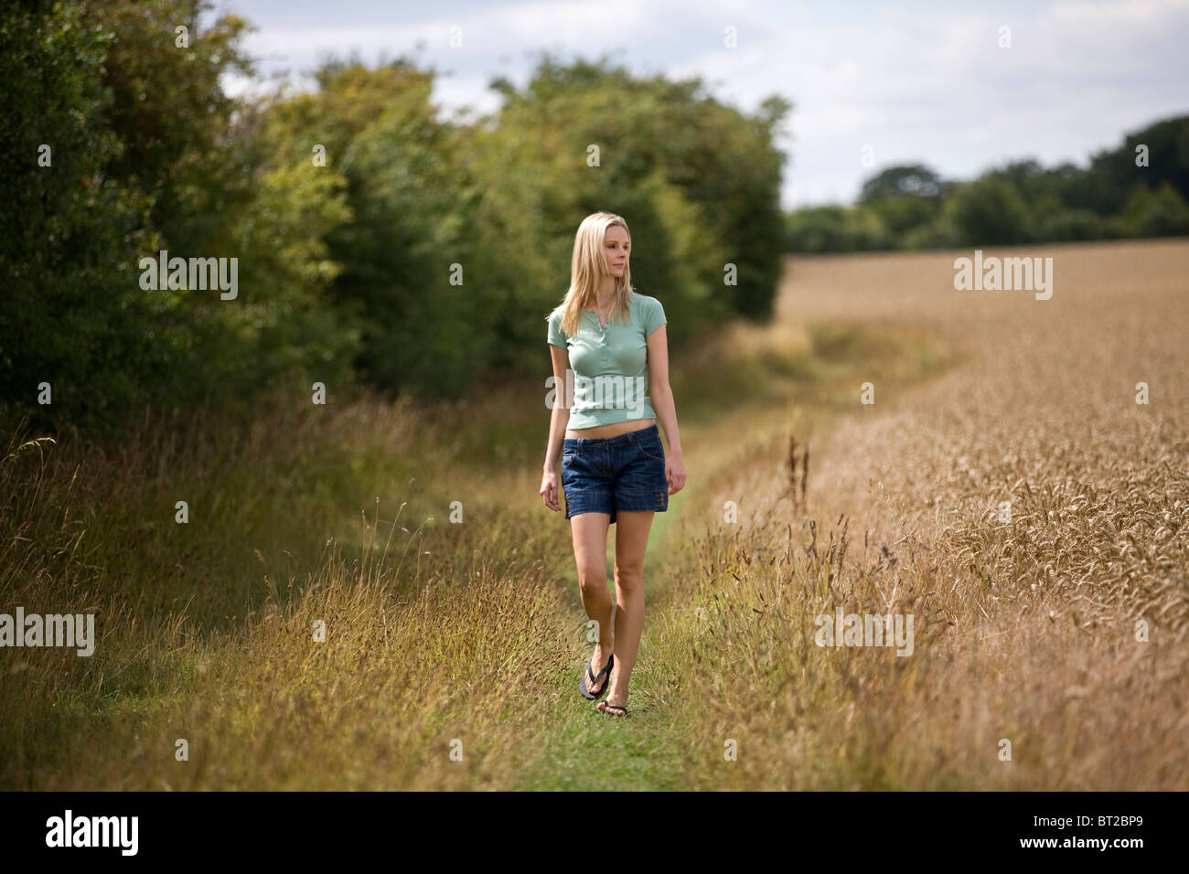 A woman walking in the countryside Stock Photo - Alamy