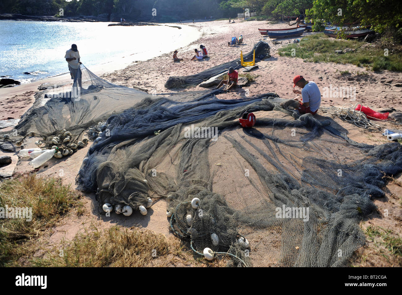 Fishermen repair their nets hi-res stock photography and images - Alamy