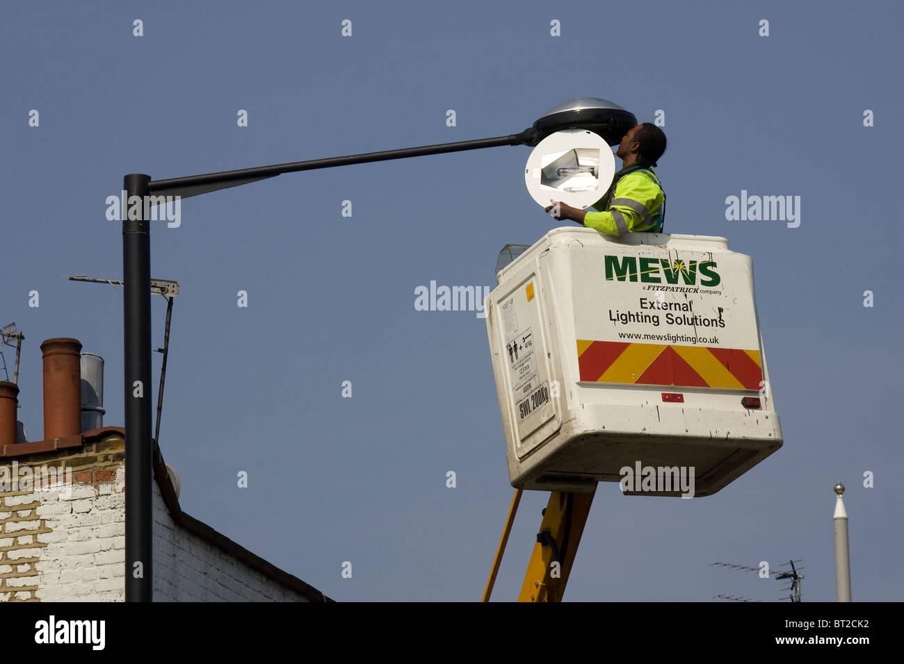 Repairing a bulb on a roadside lamp post Stock Photo - Alamy