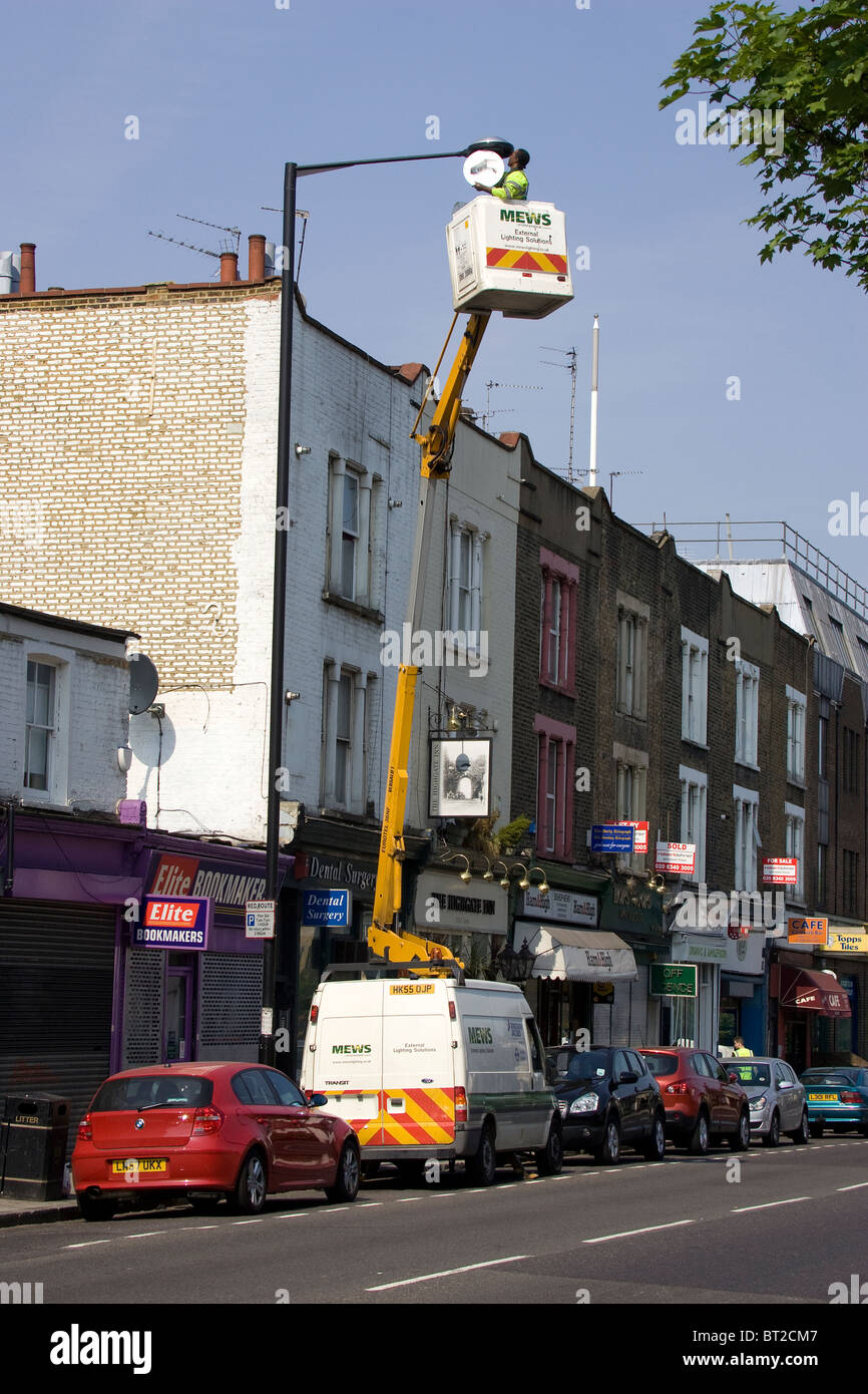 Repairing street light with a cherry picker hi-res stock photography ...