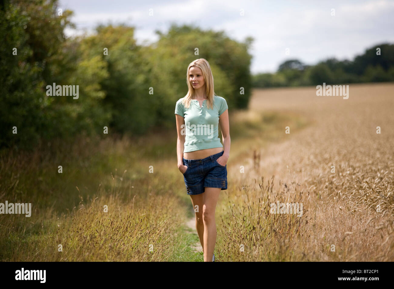 A woman walking in the countryside Stock Photo - Alamy