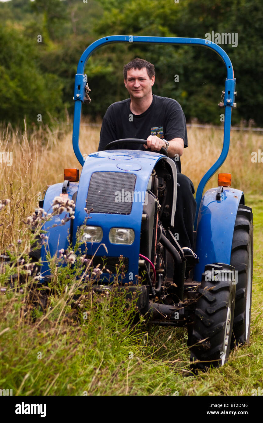 hay making on a compact tractor Stock Photo - Alamy