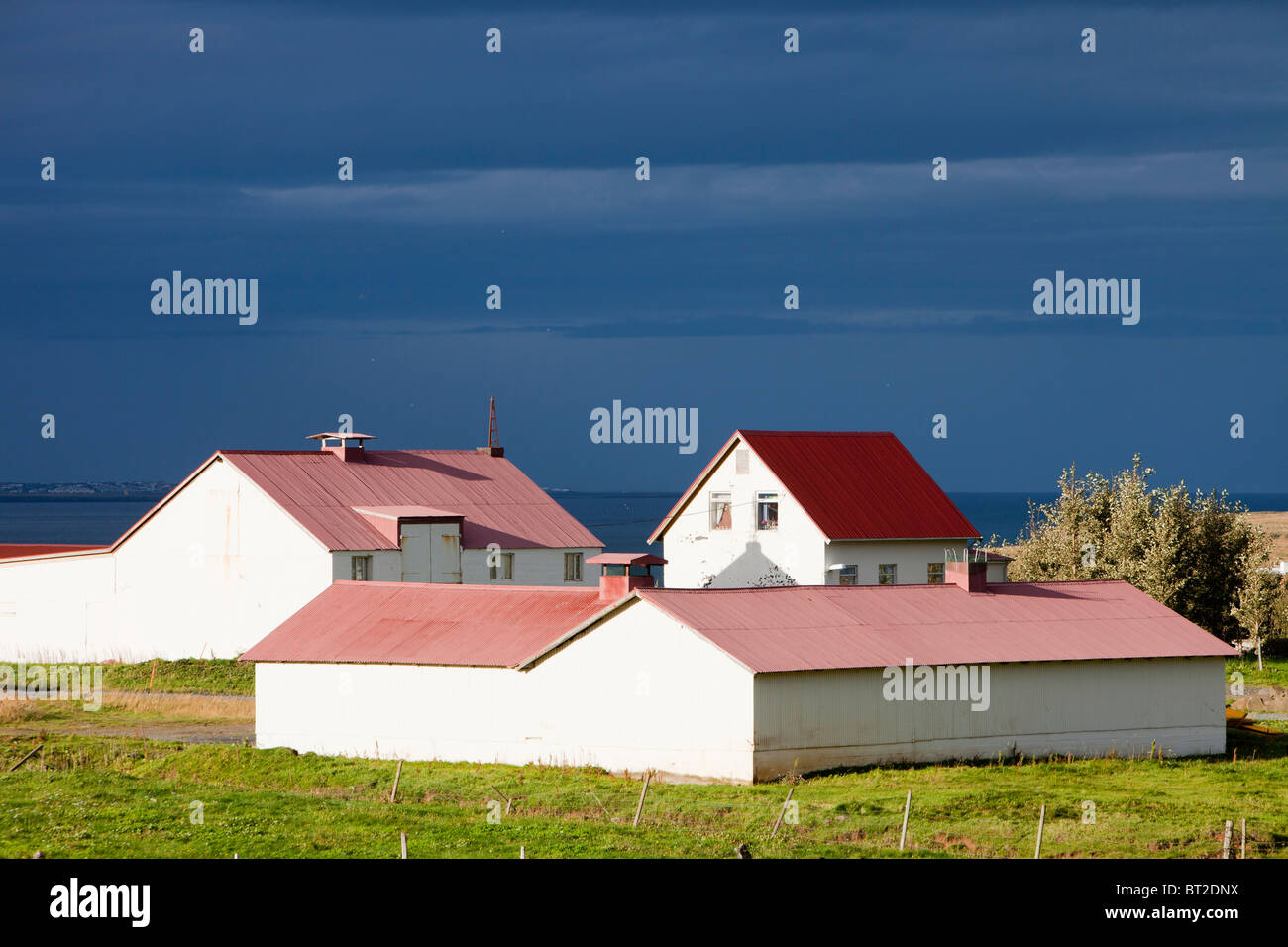 An Icelandic farmhouse near Reykjavik, Iceland, with a stormy sky ...
