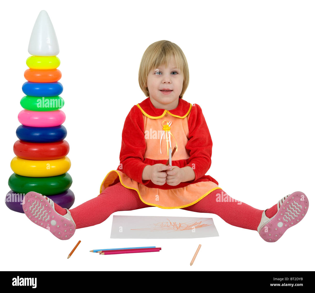 Little girl and toy pyramid and crayons on white Stock Photo - Alamy