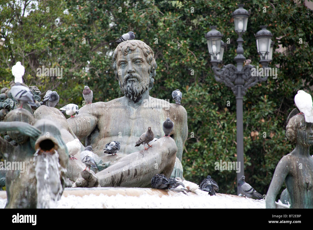 Pigeons on the statues of the the Turia Fountain, Plaza de la Virgen ...