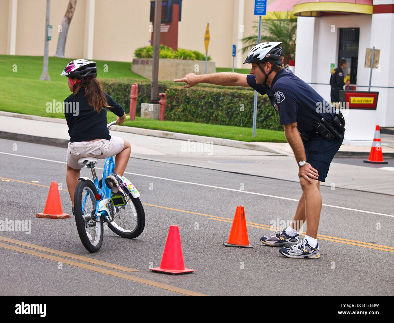 Redondo police officer directs children on their bikes negotiating ...