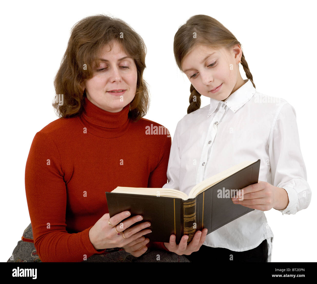 Woman and girl reading book on white Stock Photo - Alamy