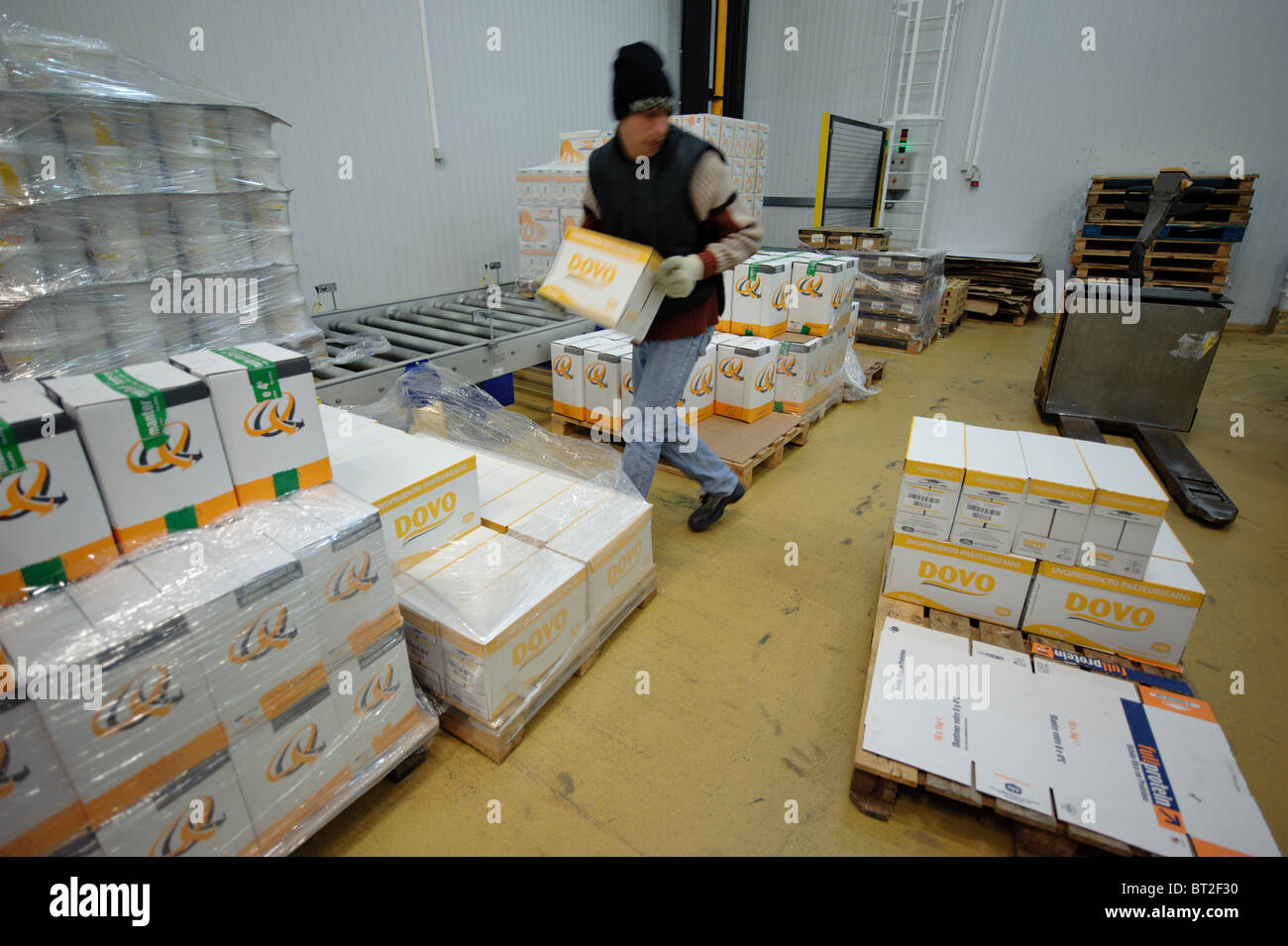 One man moving packages in the warehouse of a factory Stock Photo - Alamy