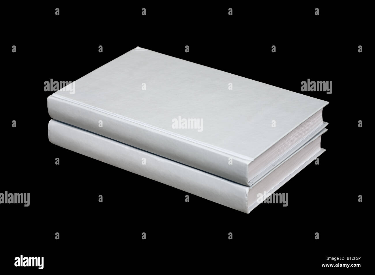 Two books lying a pile on a black background Stock Photo - Alamy