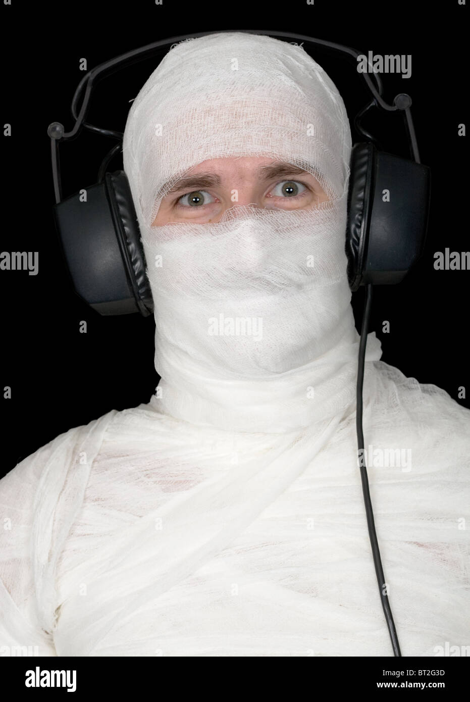 Man in bandage with ear-phones on black Stock Photo - Alamy