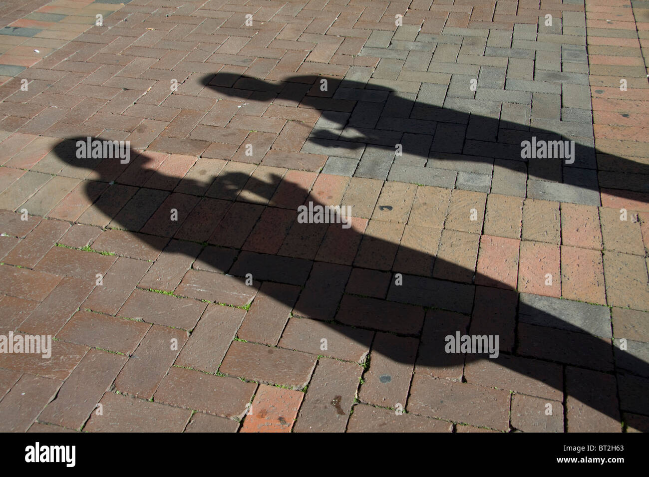 Long Shadows of two Males in conversation in Adelaide Australia Stock ...