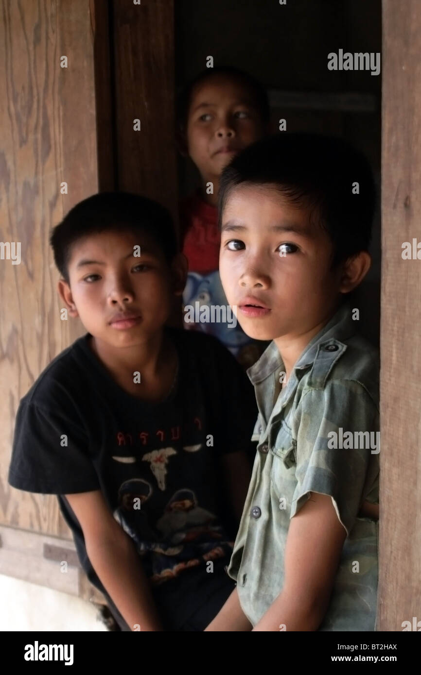 Three boy students gather in a window after school classes at the Ban ...