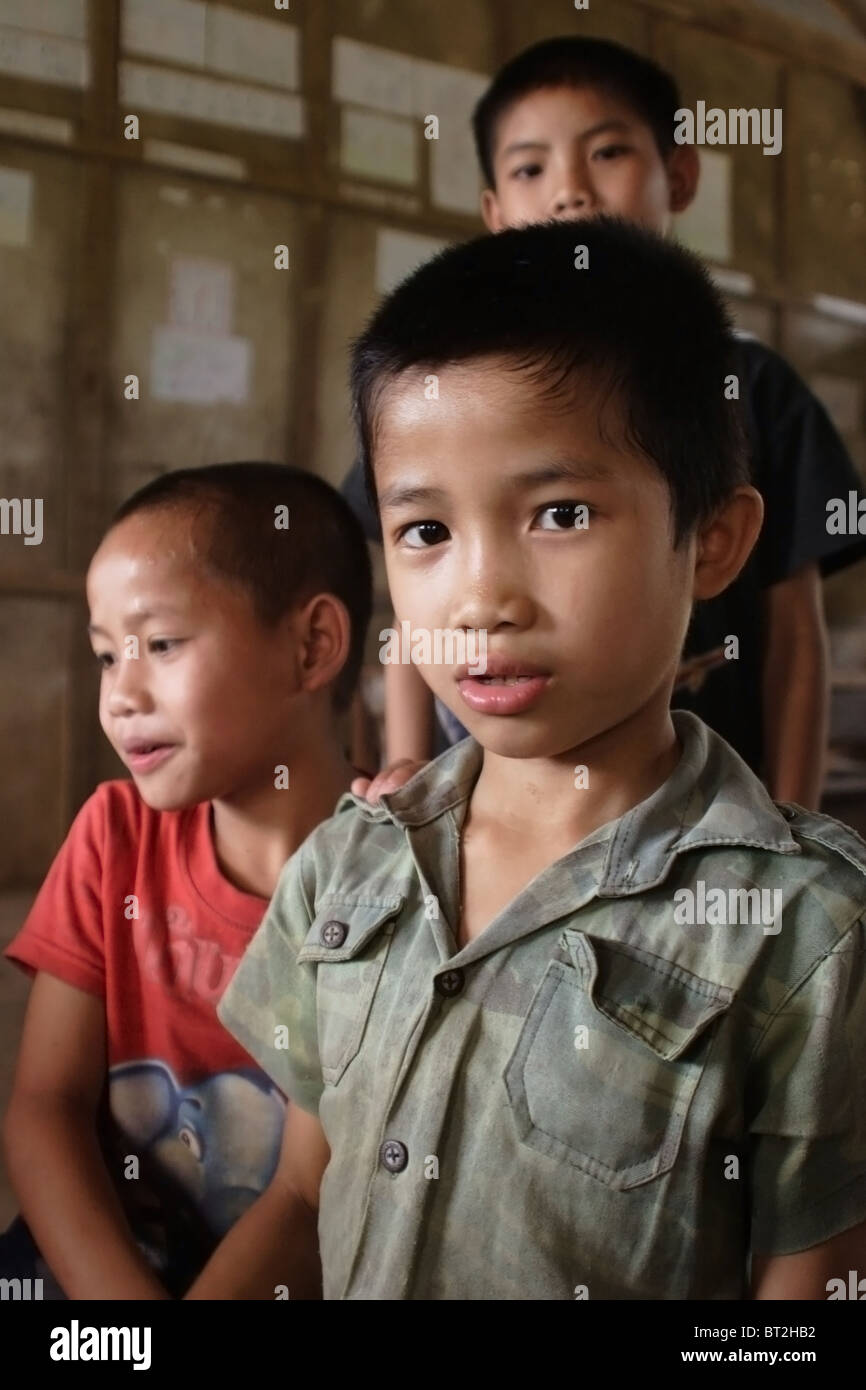 Three boy students gather inside a classroom after school classes at ...
