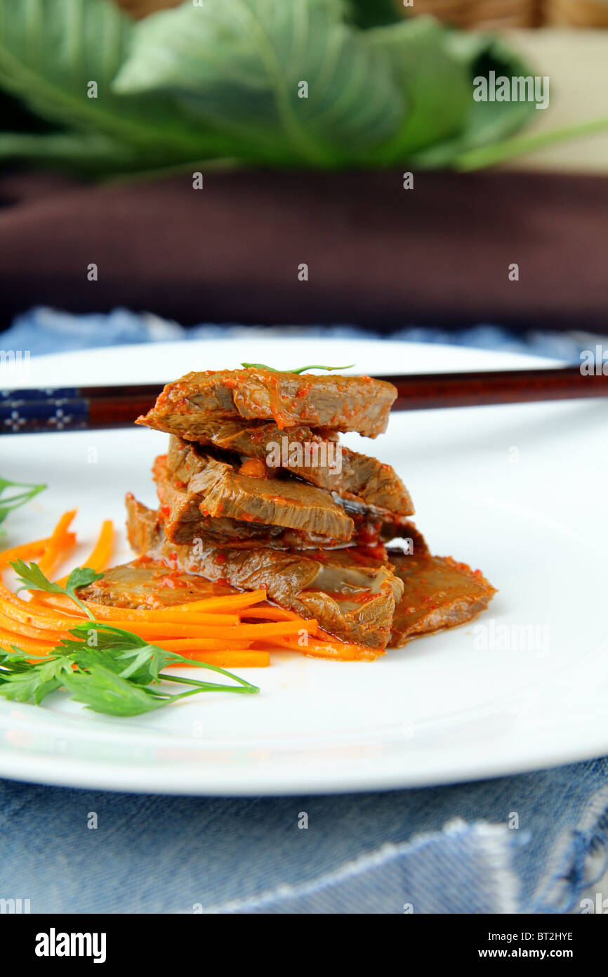 Prepared meat in Chinese on a white plate Stock Photo - Alamy
