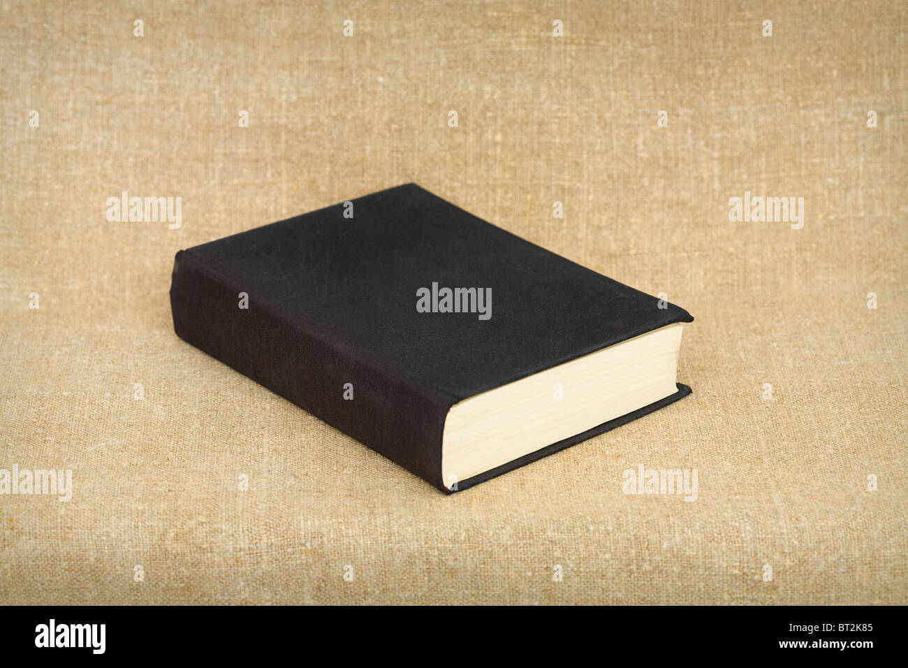 One old big black book on brown canvas background Stock Photo - Alamy