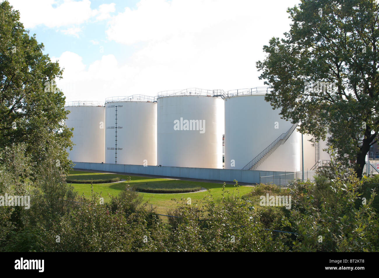 four fuel tanks in a row Stock Photo - Alamy