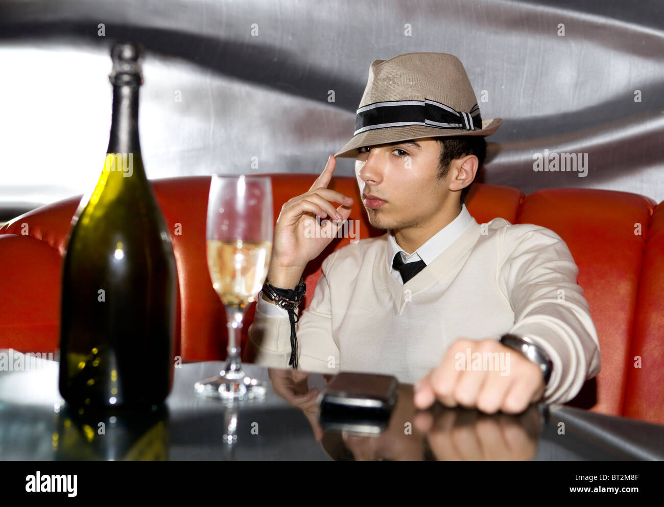 Attractive man drinking in cocktail party at night club Stock Photo - Alamy