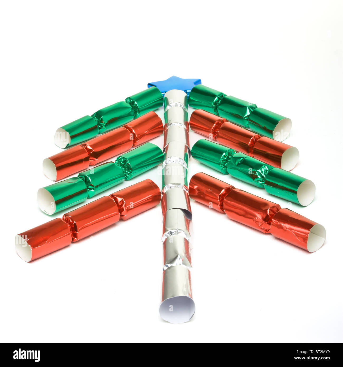 Abstract Christmas tree shape made from small shiny christmas crackers ...
