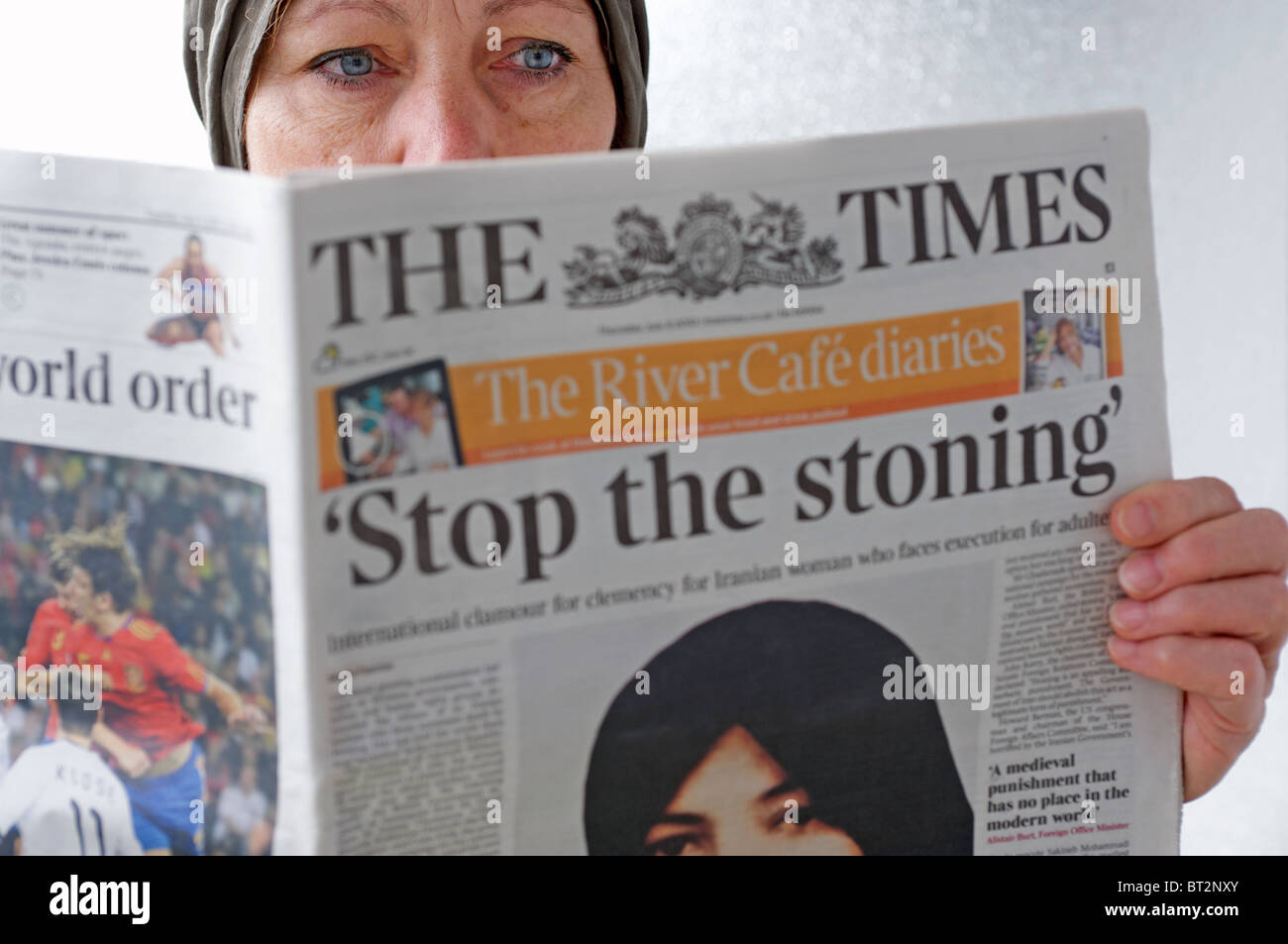 Woman reading a copy of The Times newspaper Stock Photo - Alamy