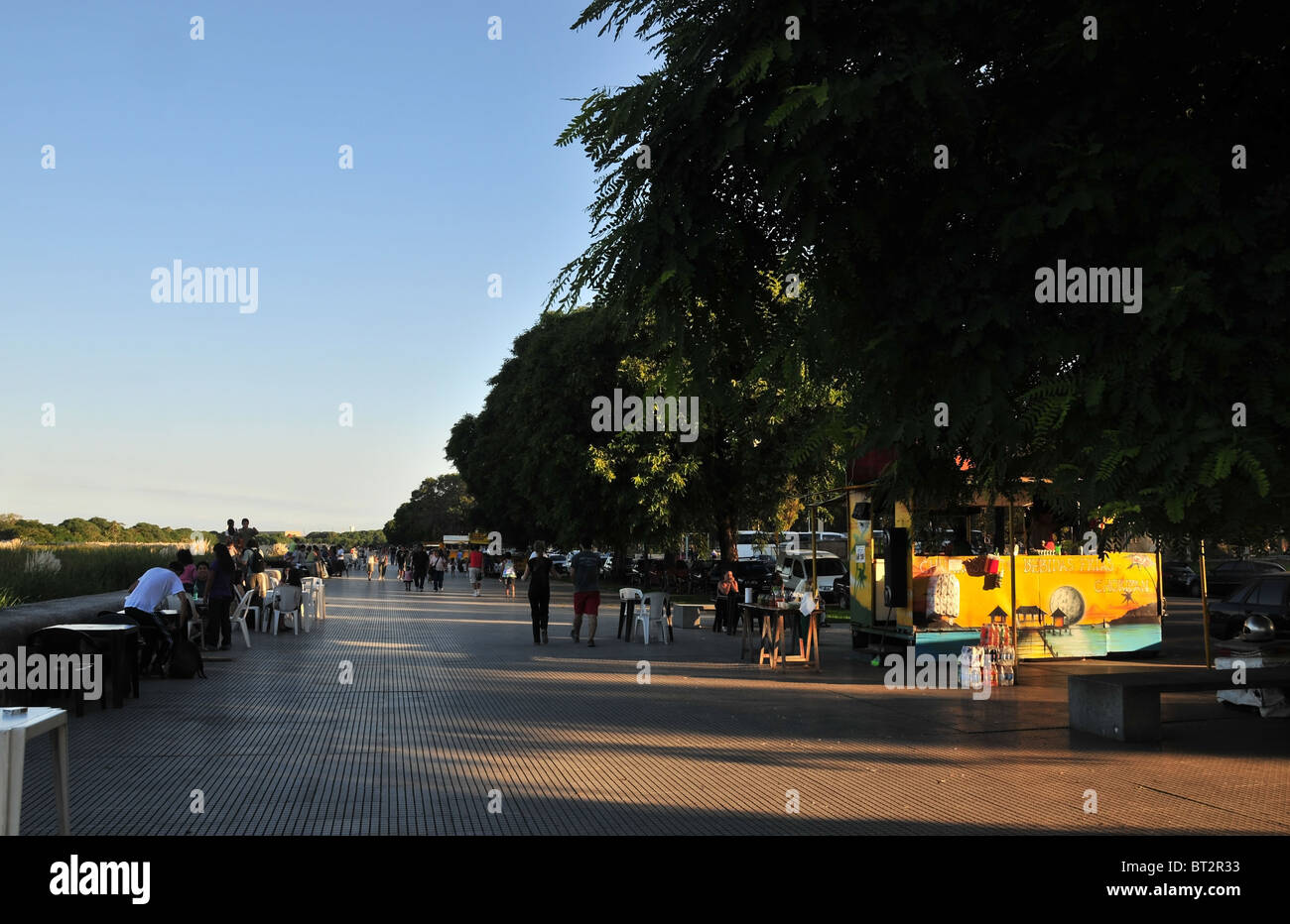 Evening light view of boulevard walkway, people walking and bright ...