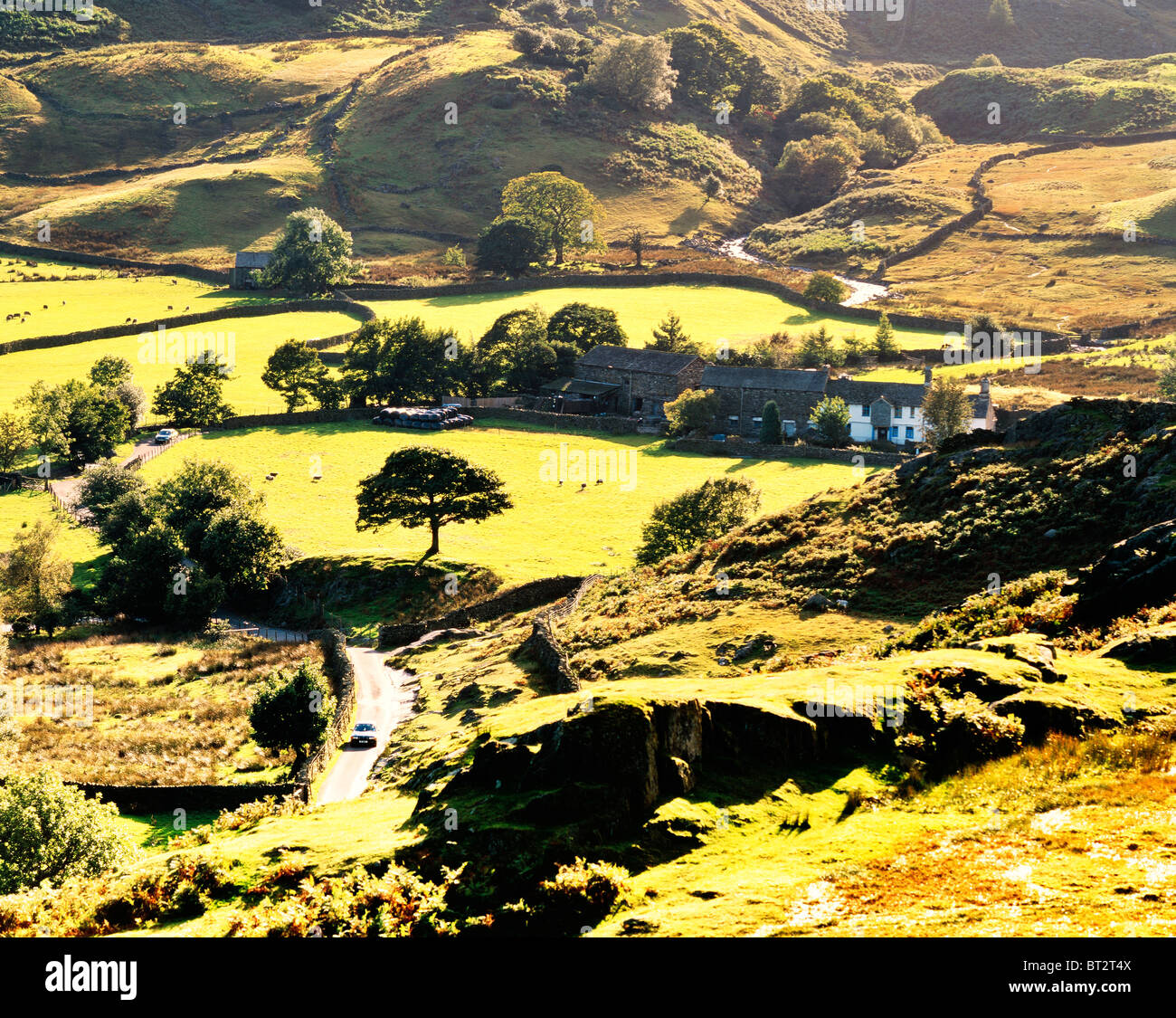 Lake District fells. S.W. over Fell Foot Farm over valley road leading ...