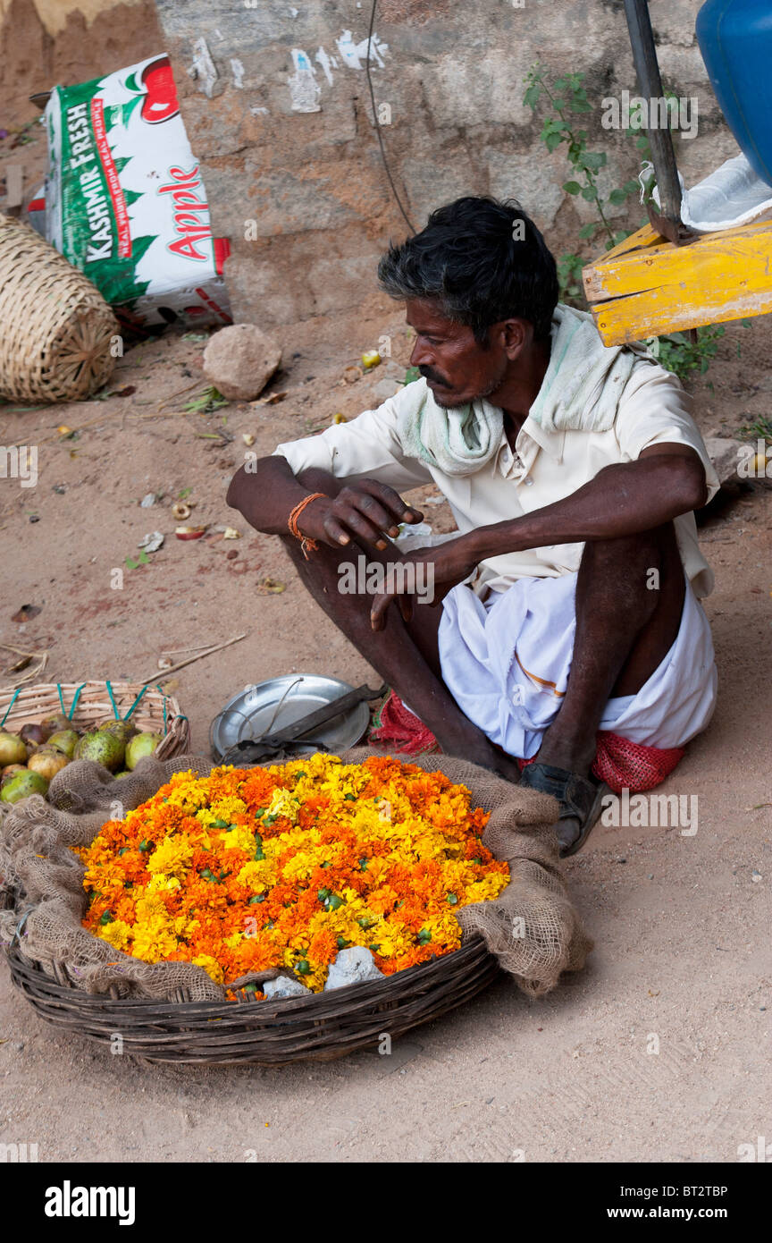 Indian man selling flowers on an Indian street. Puttaparthi, Andhra ...