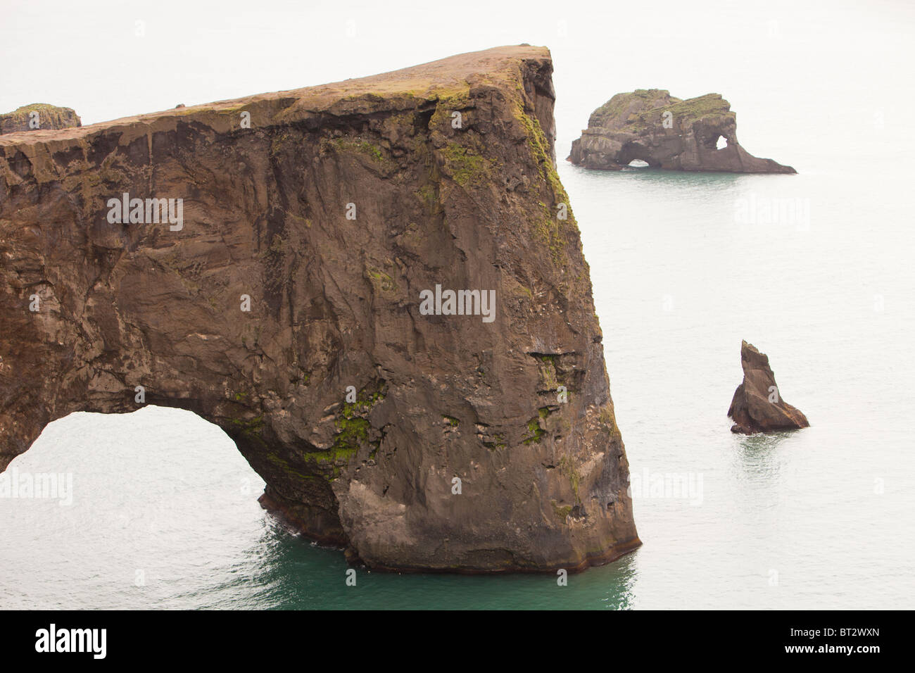 A rock arch, stack and island at Dyrholaey, near Vik on Iceland's south ...