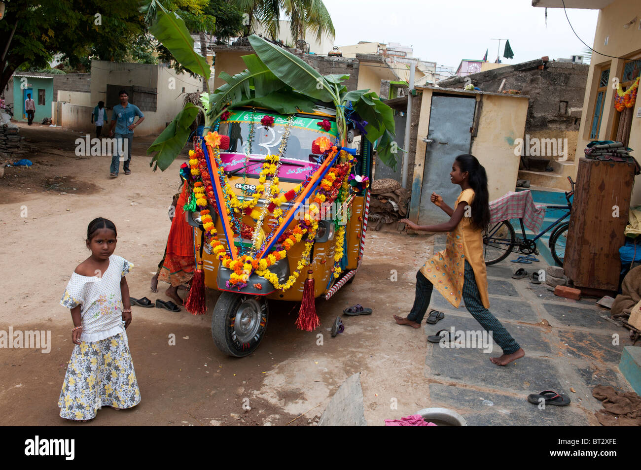 Indian rickshaw decorated in flower garlands and banana leaves during ...