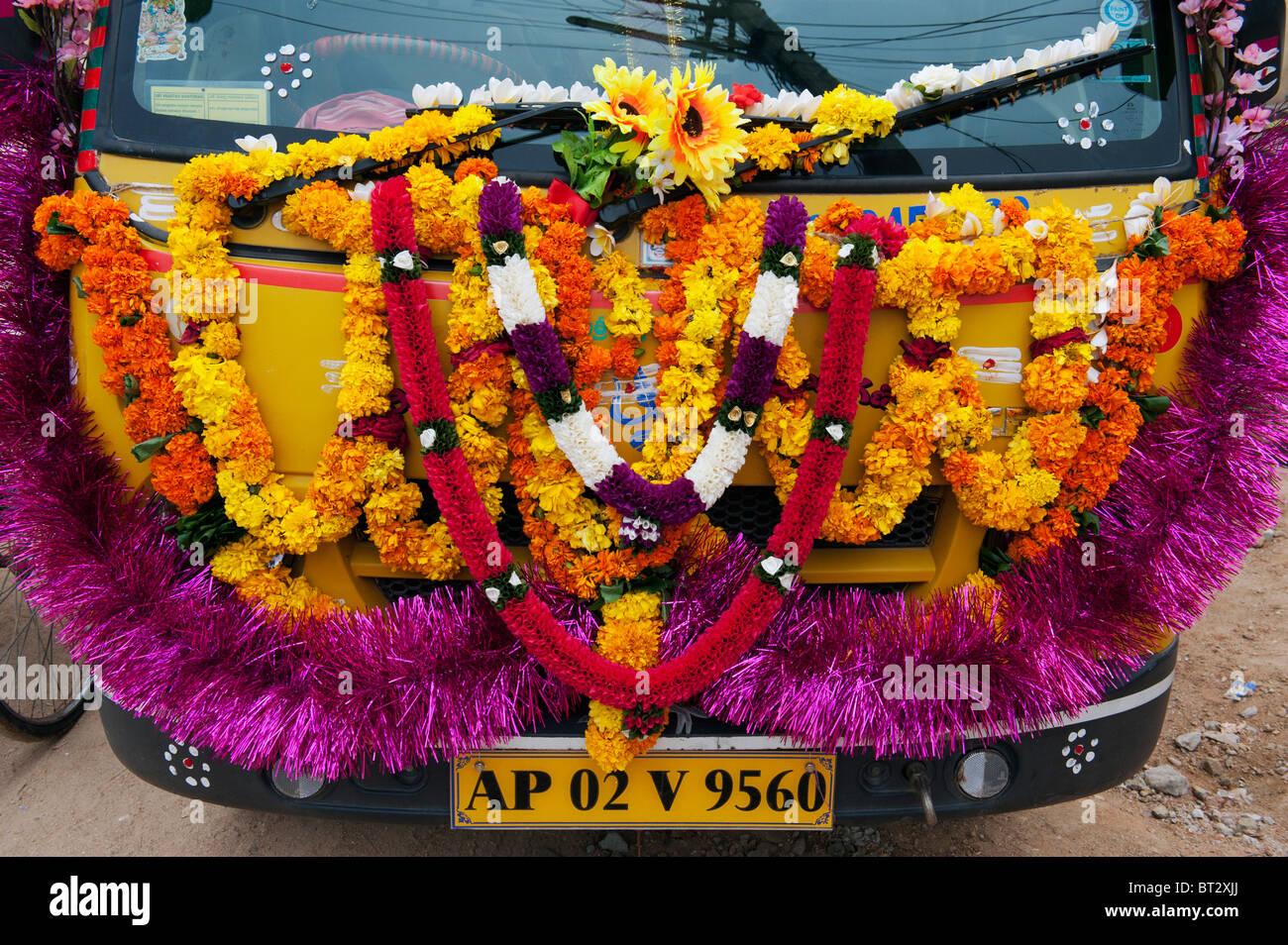 Indian taxi van decorated in flower garlands during the hindu festival ...