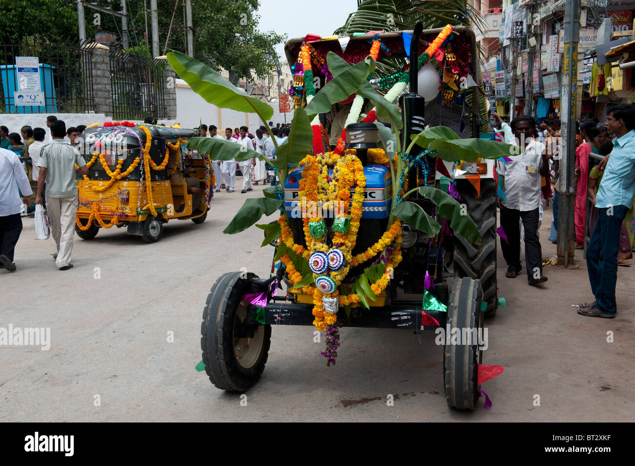 Indian Tractor and rickshaw decorated in flower garlands and banana ...