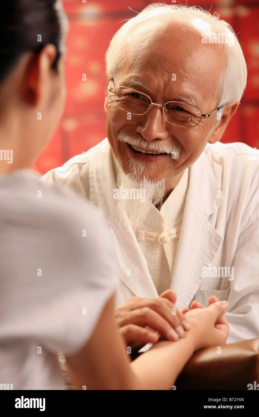 Chinese traditional herbalist doctor taking patient's pulse Stock Photo ...