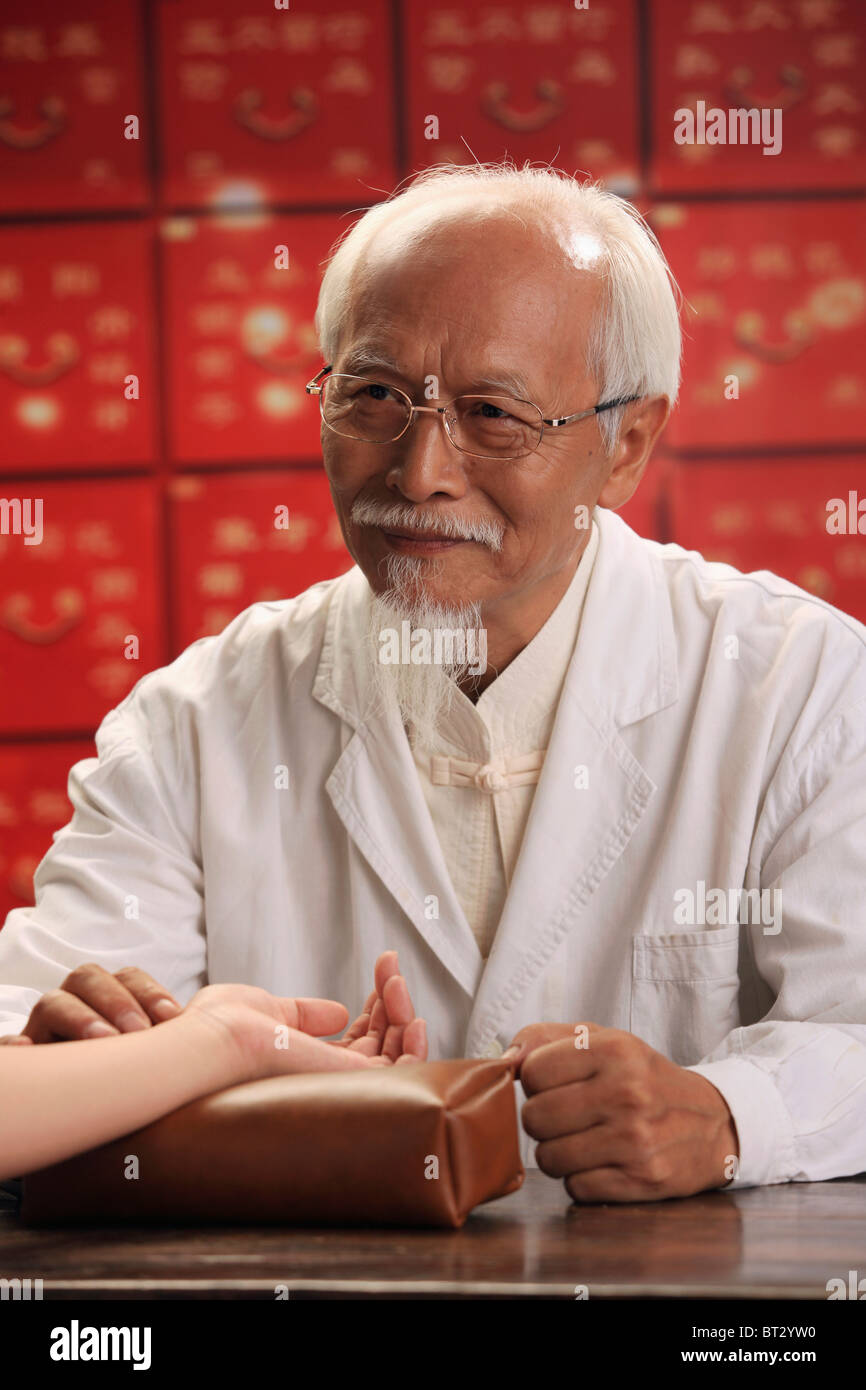 Chinese traditional herbalist doctor taking patient's pulse Stock Photo ...