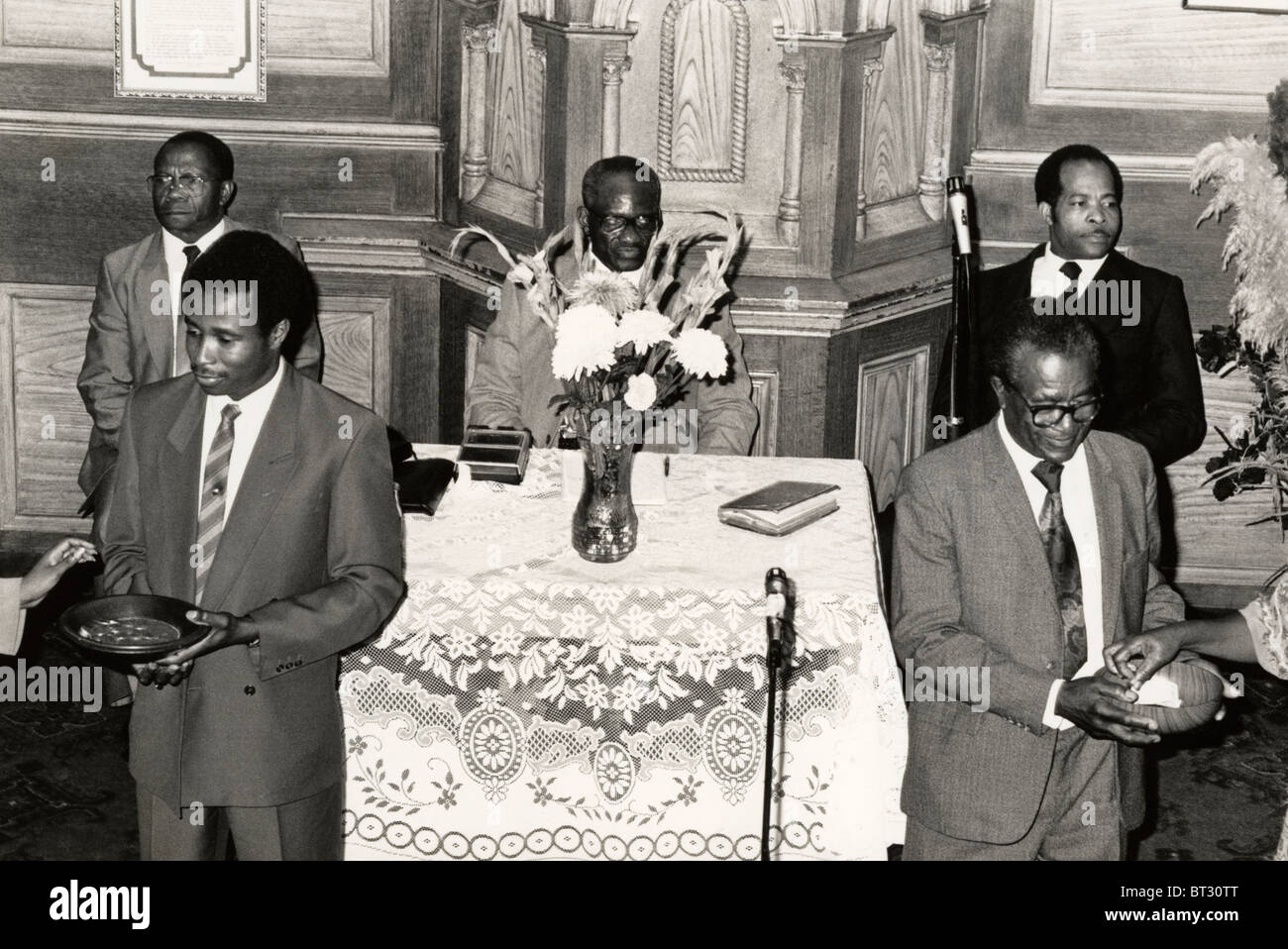 Collecting the offering after a service at New Testament Church of God ...