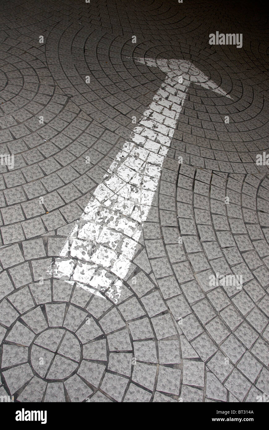arrows painted on block paved street in Singapore Stock Photo - Alamy