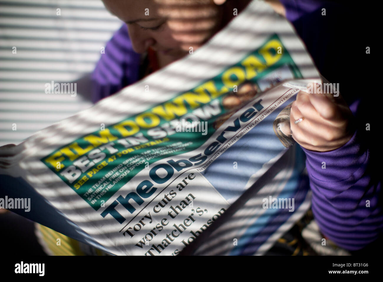 The Observer newspaper reader London UK Stock Photo - Alamy